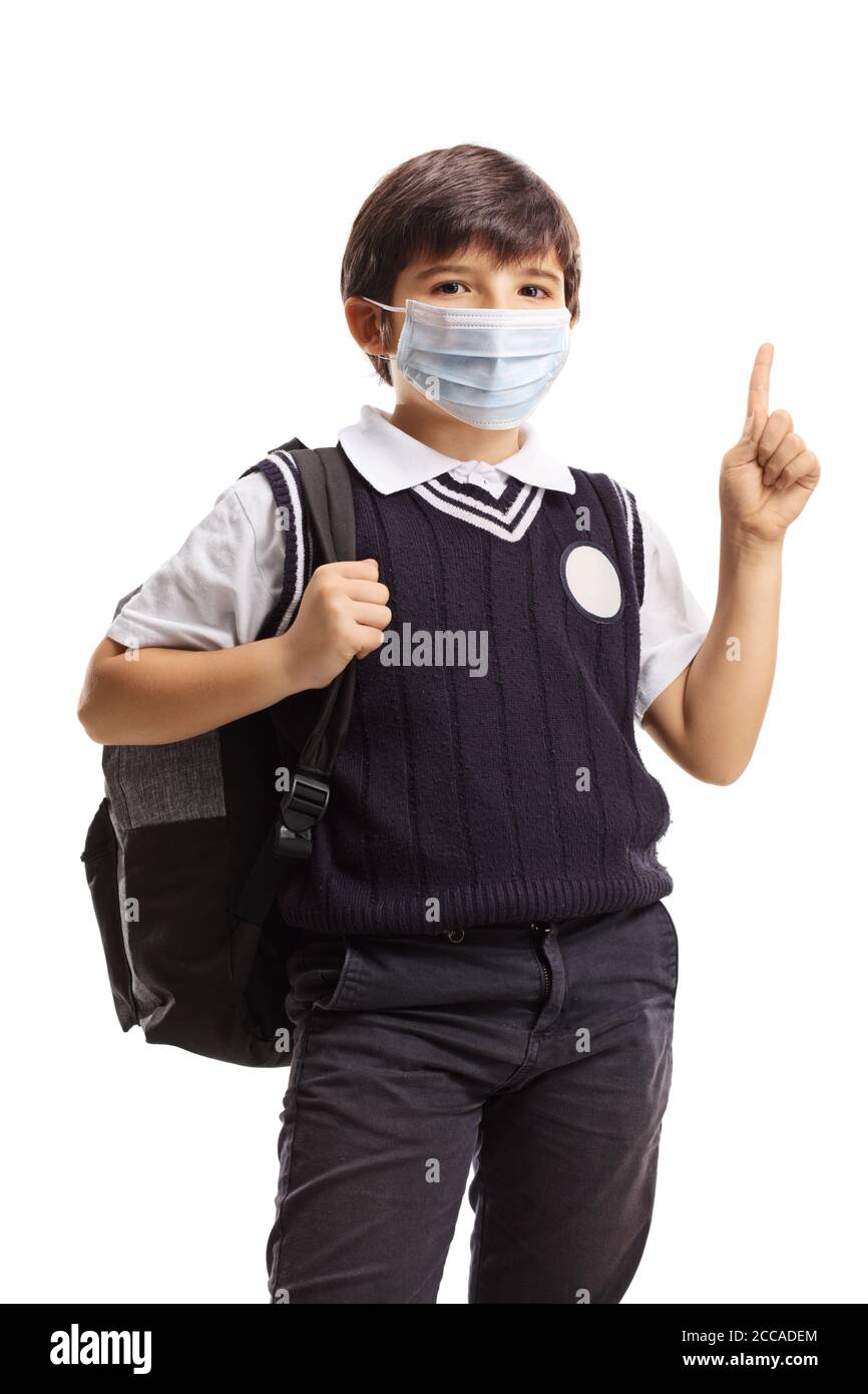 Schoolboy with books and backpack pointing up and wearing a protective ...