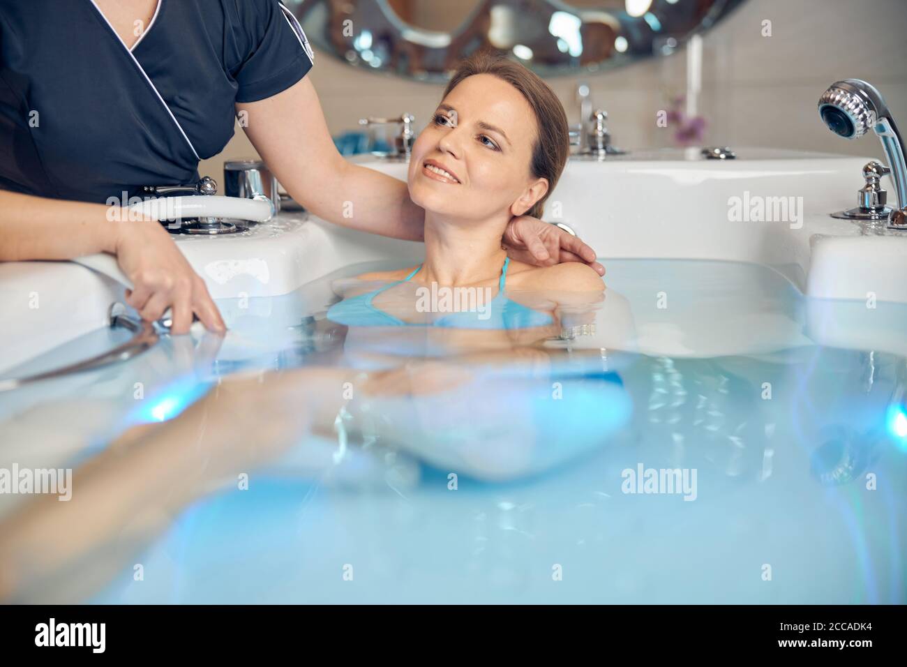 Tranquil female patient getting an underwater massage Stock Photo - Alamy