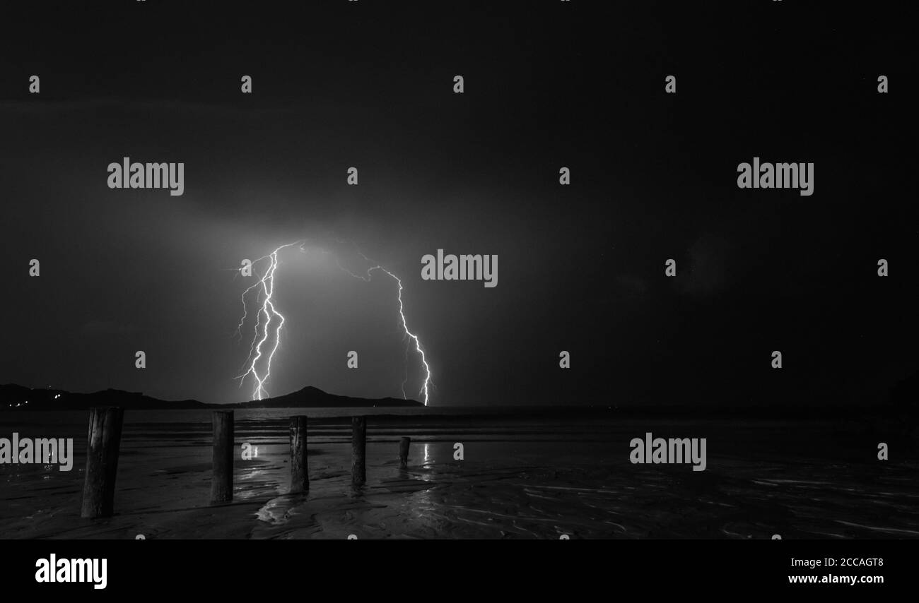 Stunning grayscale shot of a distant lightning strike from a pier Stock ...