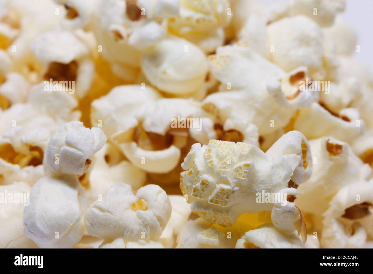 lots of yummy popcorn on white background Stock Photo - Alamy