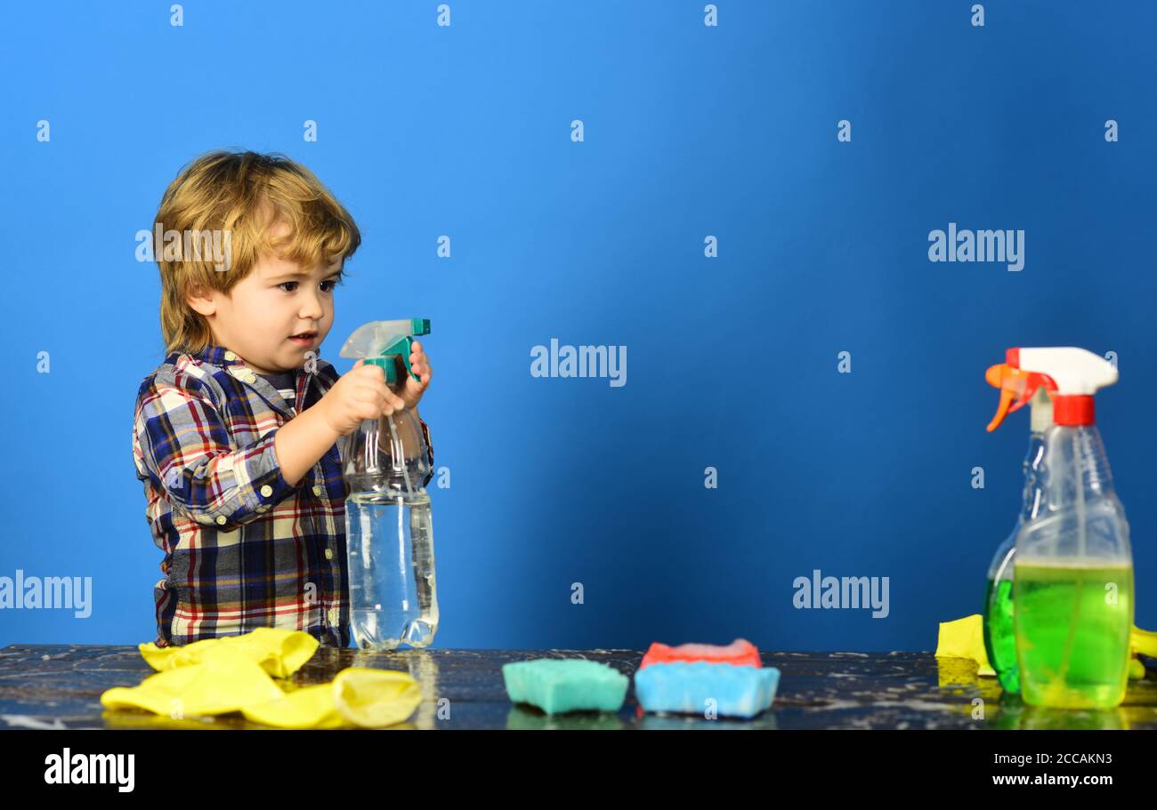 Boy in checkered shirt on blue background. Cleaning activities concept ...