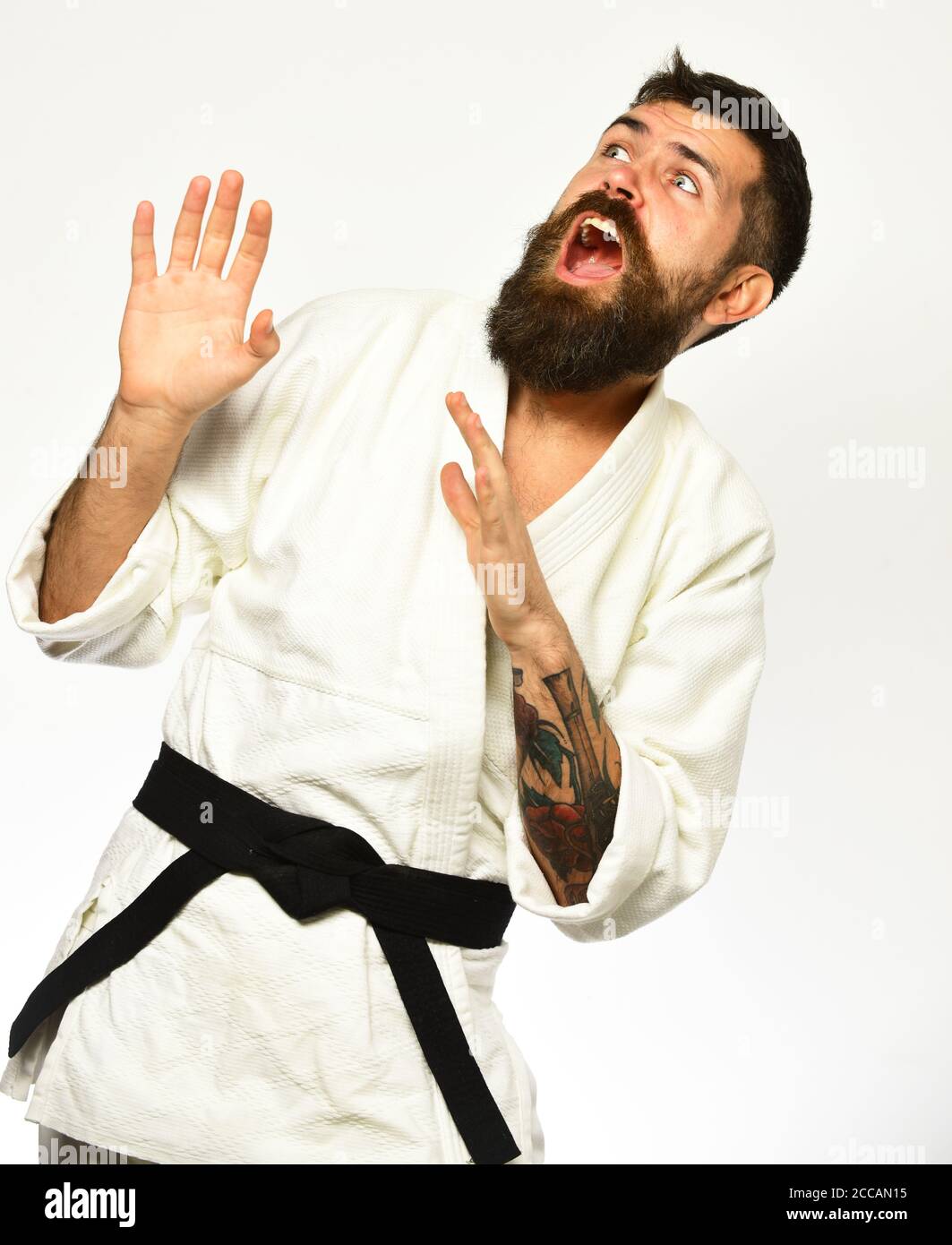 Man with beard in white kimono on white background. Healthy lifestyle ...