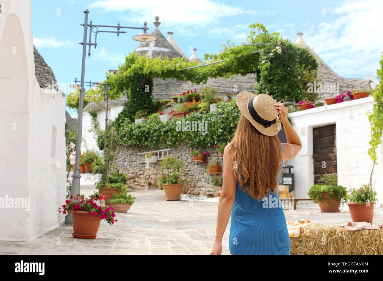 Beautiful tourist girl visiting Alberobello old town with the ...
