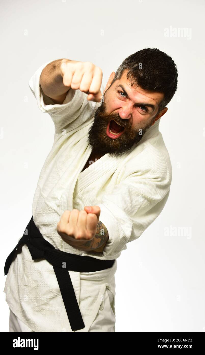 Man with beard in white kimono on white background. Judo master with ...