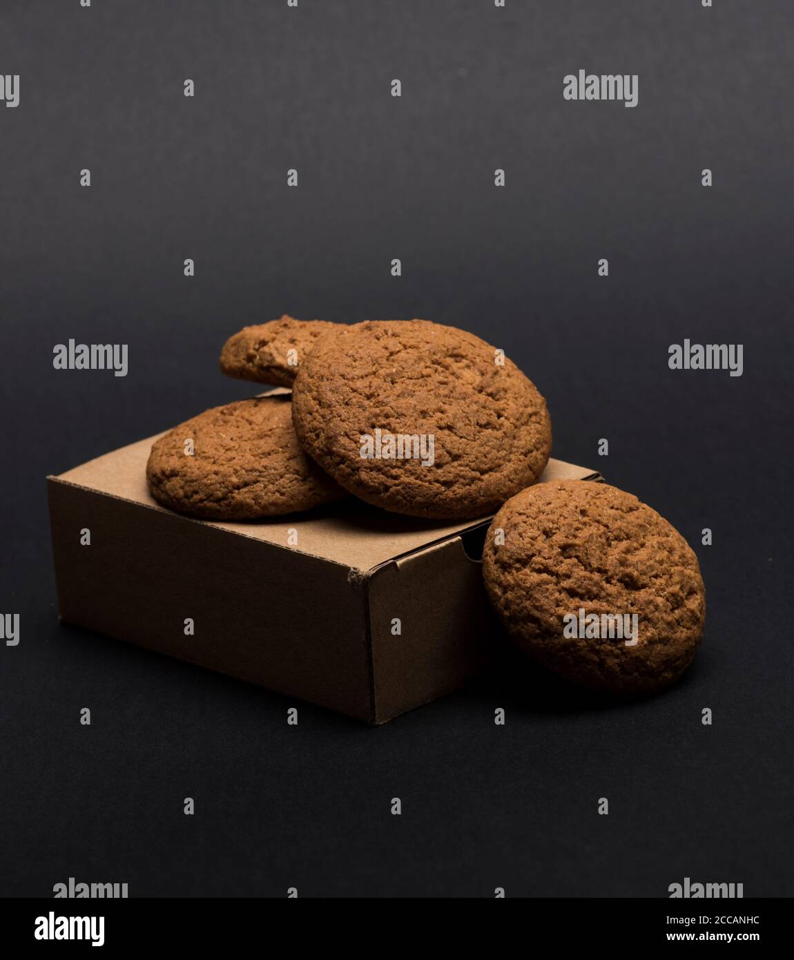 Cookies in carton box on dark grey background. Nutrition and bakery ...