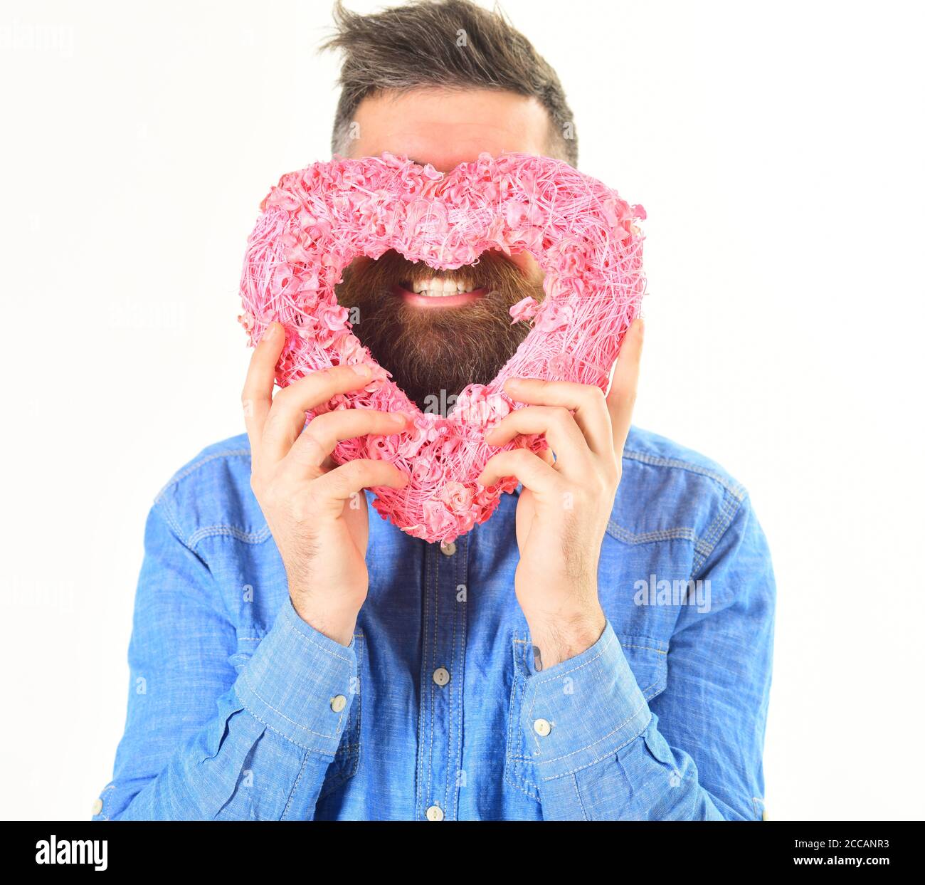 Man with mustache holds pink heart isolated on white background ...