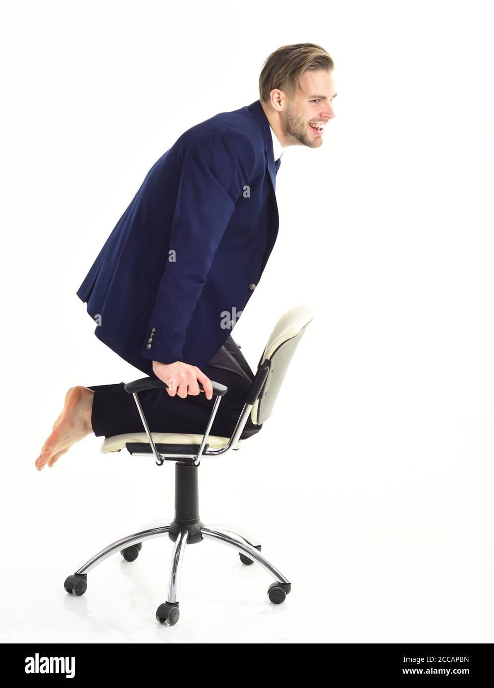 Guy in office suit has fun during coffee break. Manager rides on his ...