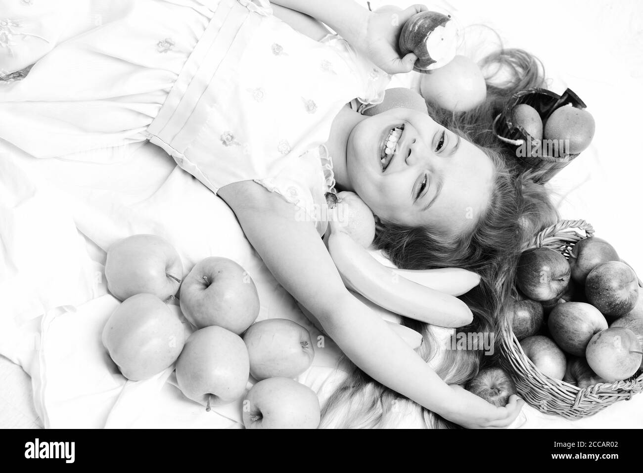 fruit and girl. cute baby girl laying with colorful fruits in basket ...
