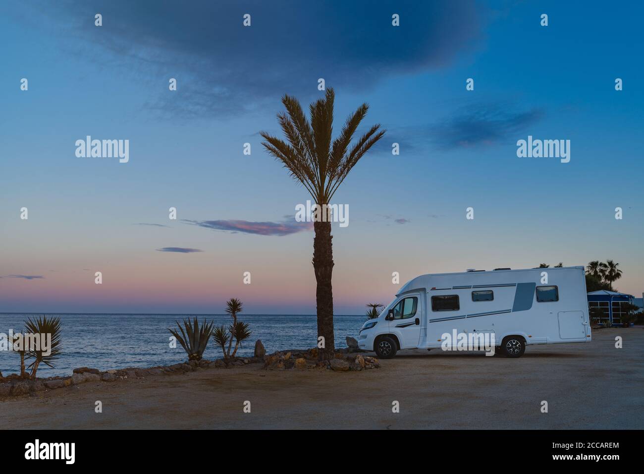 Caravan home van parked on the beach at sunset during holidays Stock ...