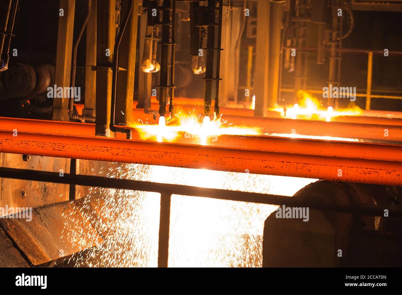 Steel Billets at Torch Cutting. Hot square steel bloom on the roll ...
