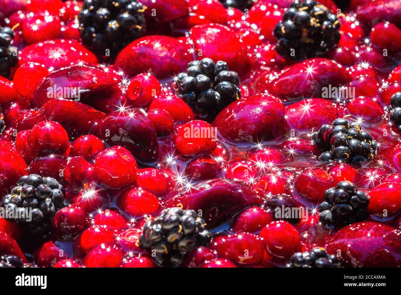 close up of a bowl of mixed berries under bright sunlight reflecting a ...