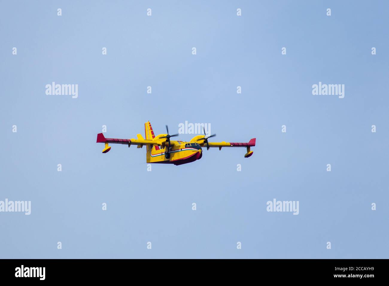 Close up of a fire fighting water bomber airplane flying over head ...
