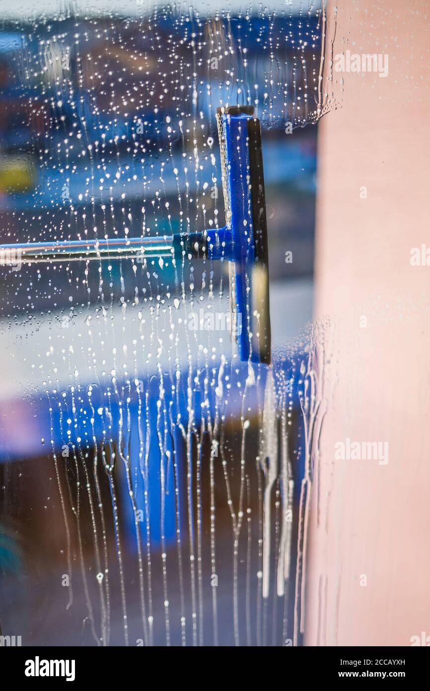 Window cleaning brush. Large window in a multi-storey building ...