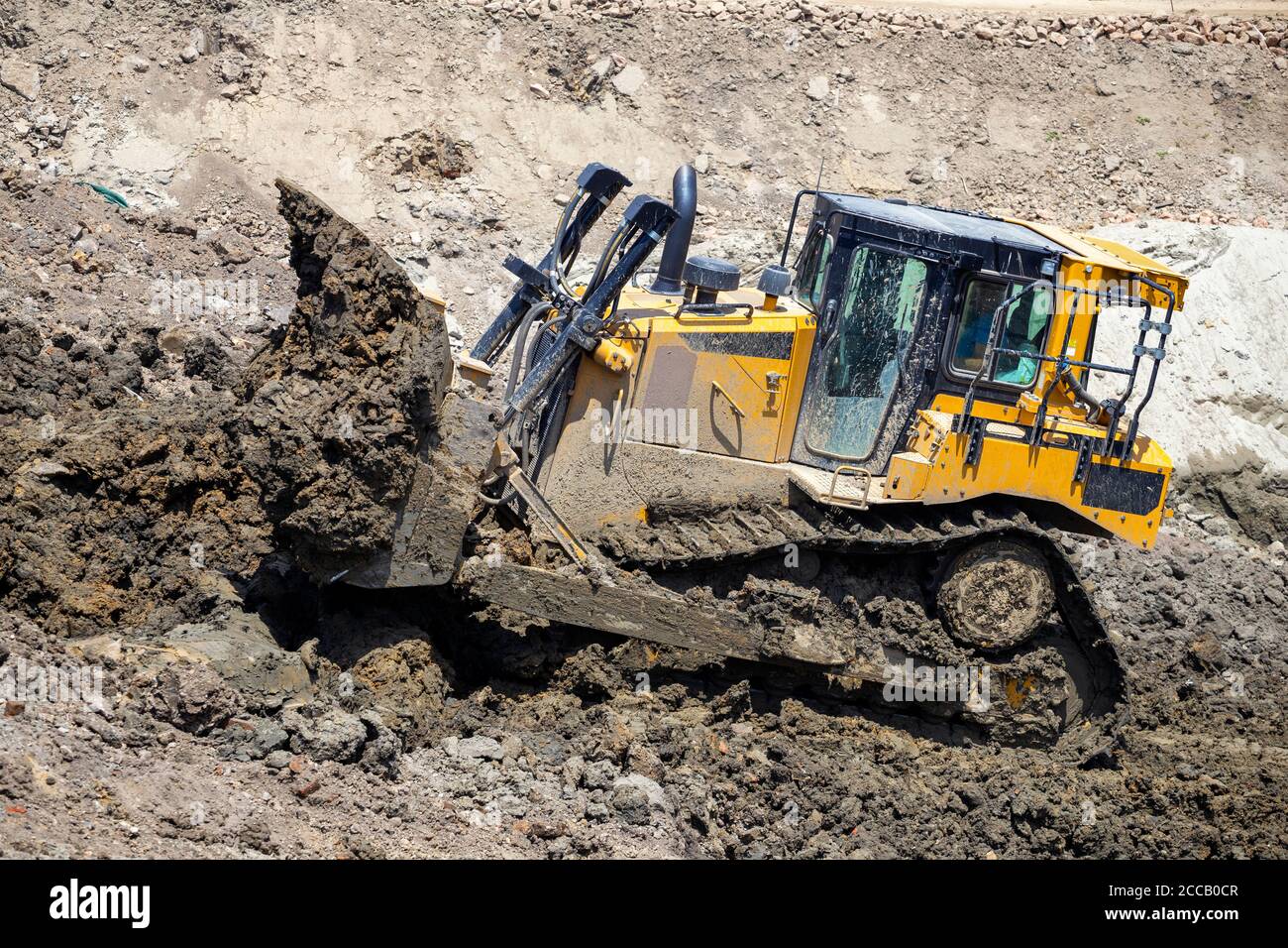 Bulldozer push large quantities of soil during construction work Stock ...