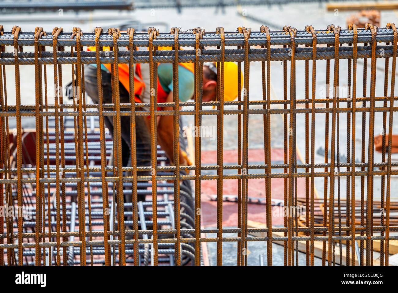 Construction worker behind the rebar, steel fixer tying steel ...