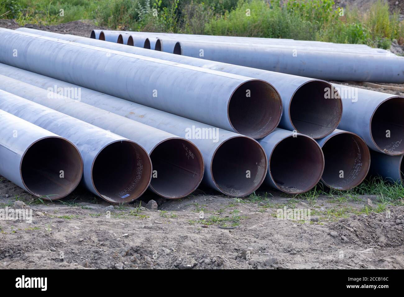 Long metal pipes laying on the ground for new water delivery system of ...
