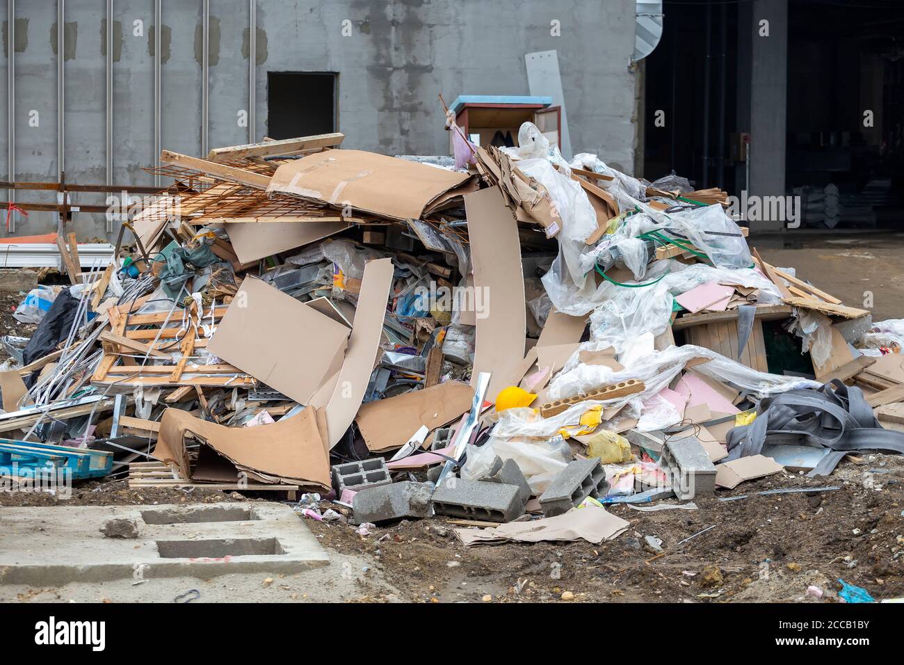 Pile of construction waste in front of an unfinished building Stock ...