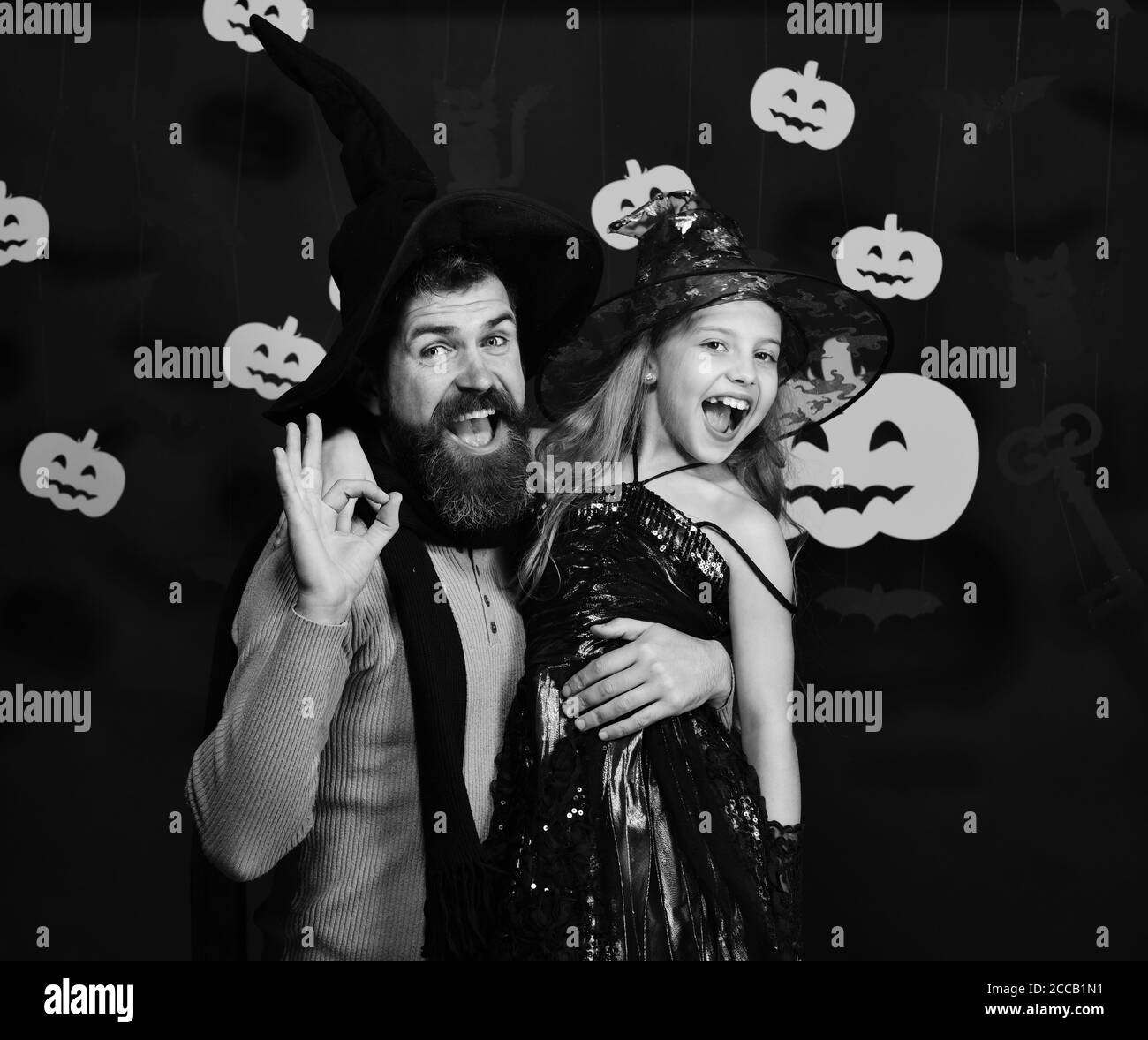 Dad and daughter in costumes. Halloween party and holiday concept. Girl ...