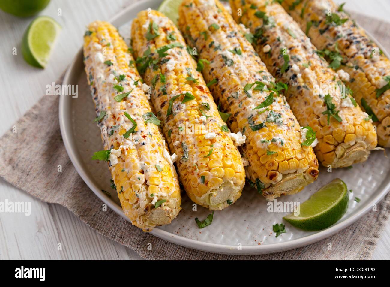 Homemade Elote Mexican Street Corn on a plate on a white wooden ...
