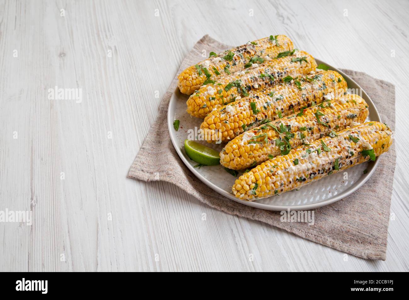Homemade Elote Mexican Street Corn on a plate, side view. Copy space ...