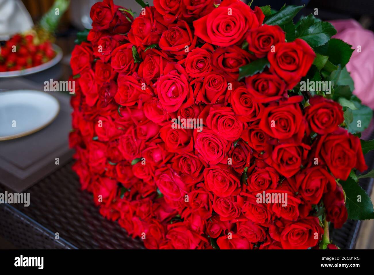 A large bouquet of red roses for a girl, fresh flowers Stock Photo - Alamy