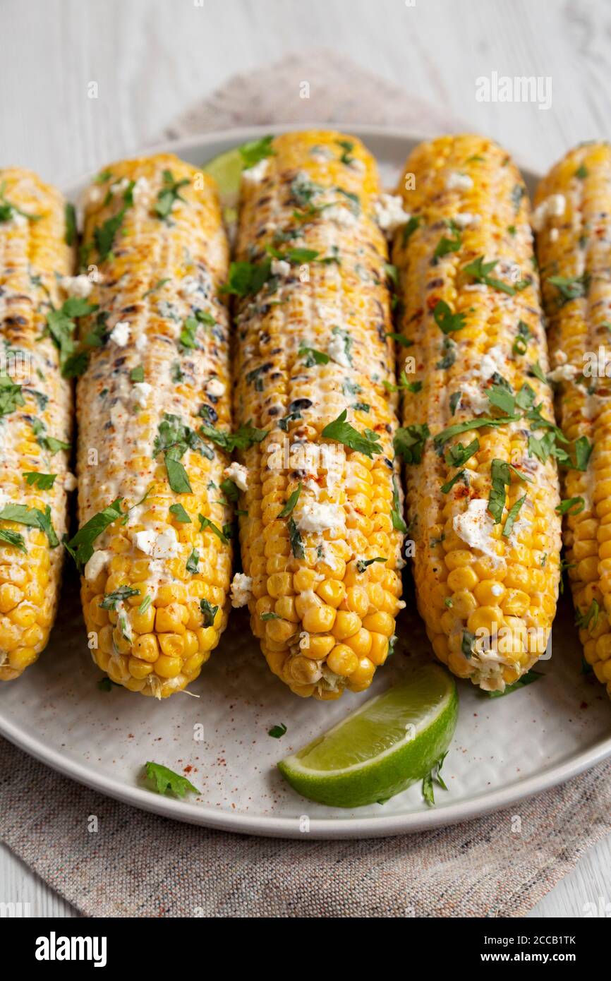 Homemade Elote Mexican Street Corn on a plate, low angle view Stock ...