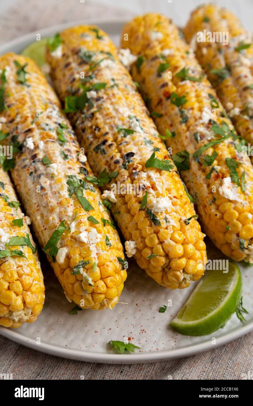 Homemade Elote Mexican Street Corn on a plate, side view. Close-up ...