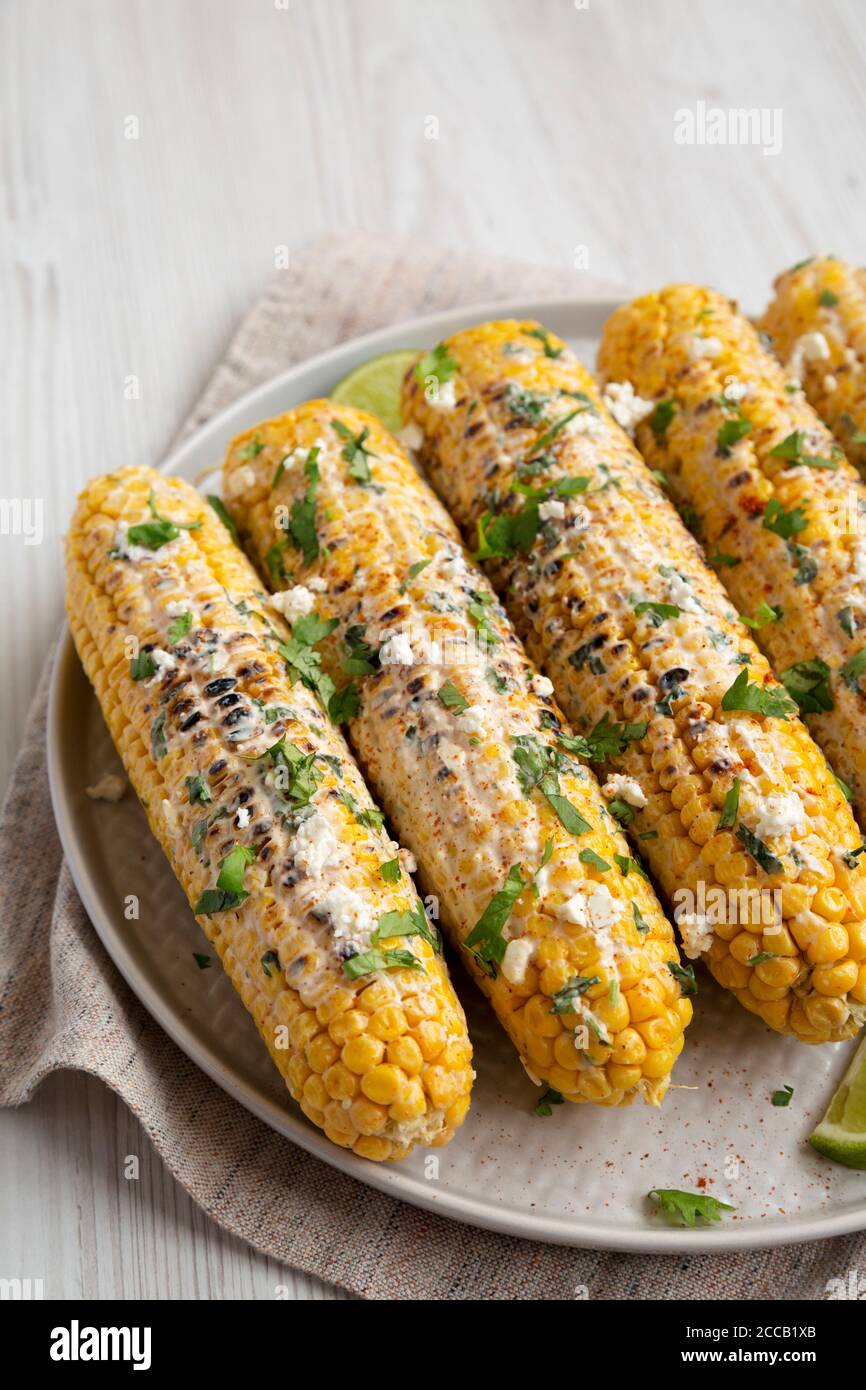 Homemade Elote Mexican Street Corn on a plate, side view Stock Photo ...
