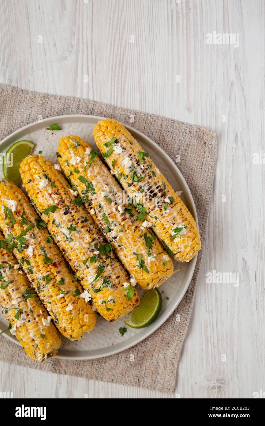 Homemade Elote Mexican Street Corn on a plate on a white wooden ...