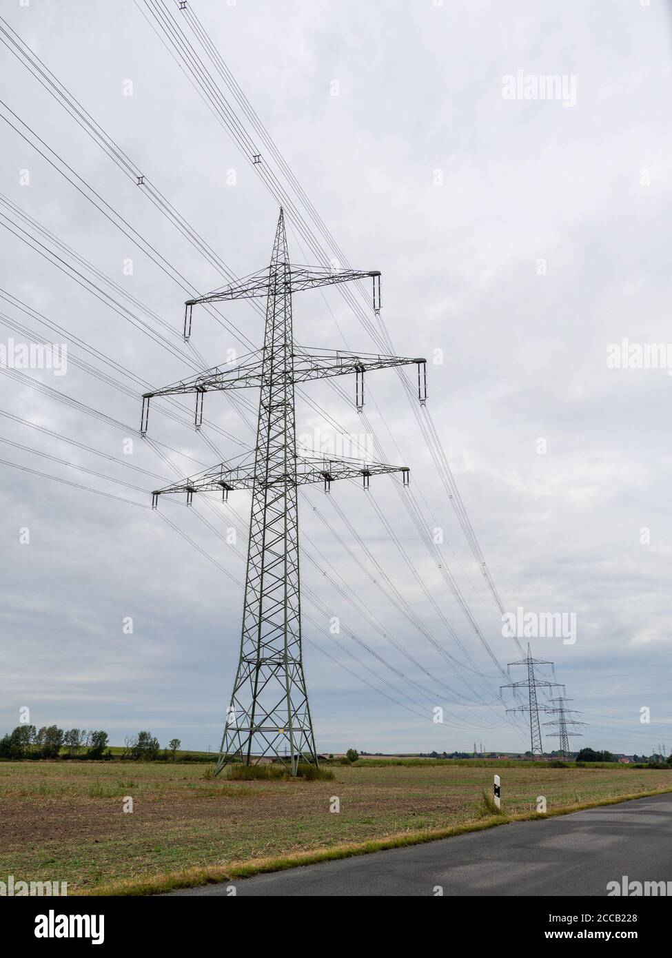 huge power poles run power lines across the country Stock Photo - Alamy