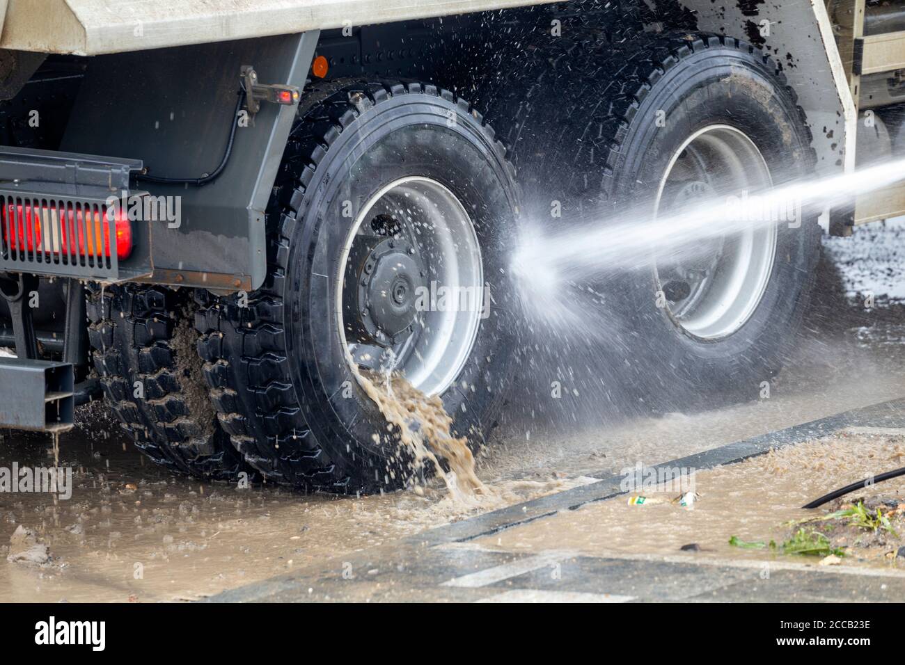 Washing truck wheels off dirt on the tires before the truck goes out of ...