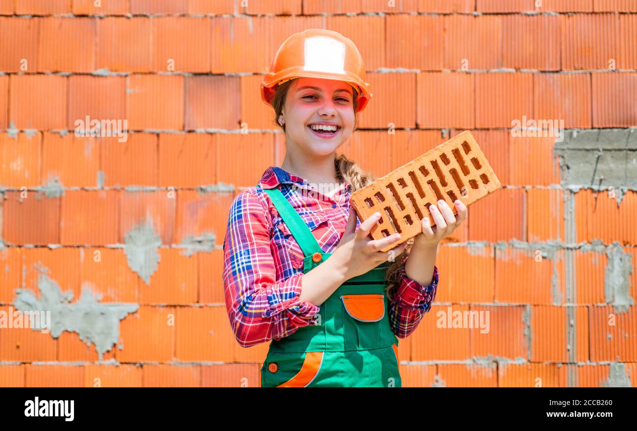 little builder with brick. child is engineer architect. building her ...
