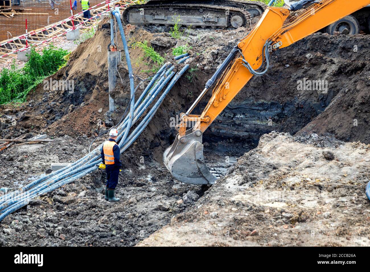 Work crews performs excavation work on the construction site ...