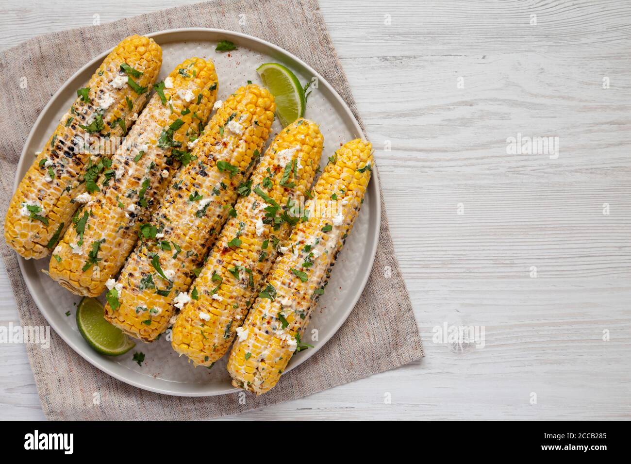 Homemade Elote Mexican Street Corn on a plate on a white wooden ...
