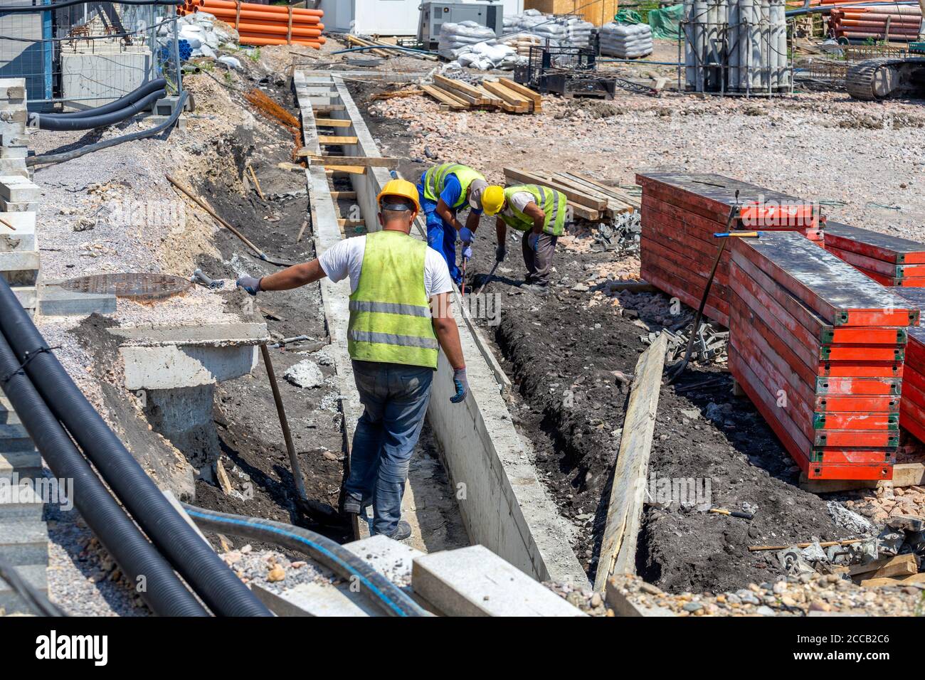 Workers are installing concrete drains to prevent flooding at ...
