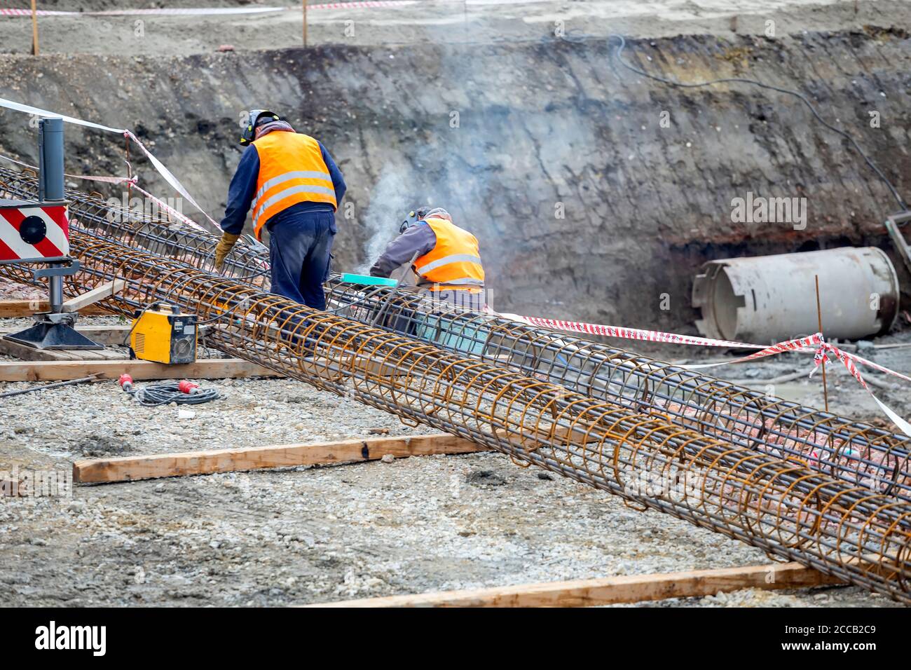 Workers welding reinforcement cages for a foundation piles. Steel ...