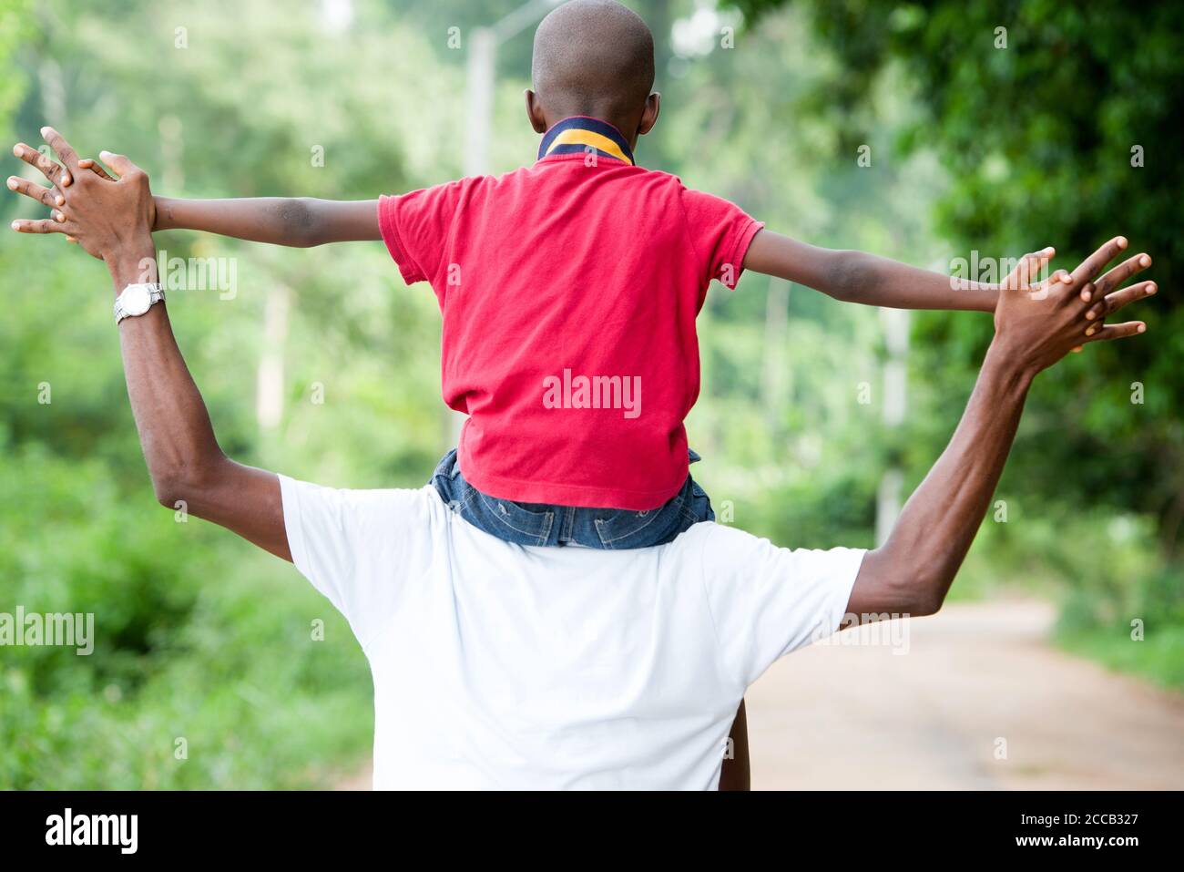 fathers Day. Father and child playing together outdoors on a road in ...