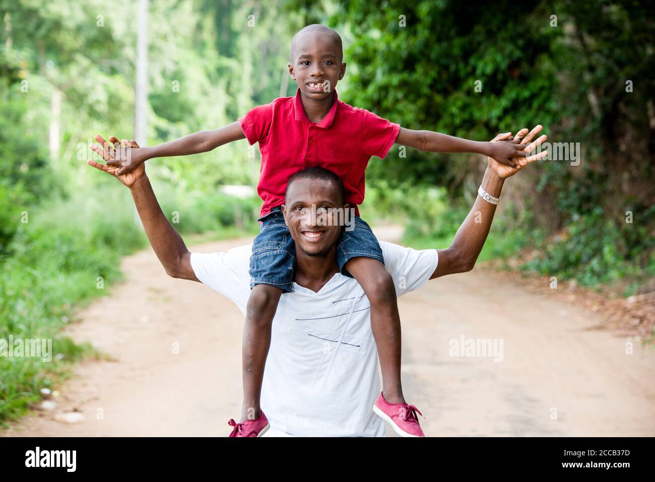 fathers Day. Father and child playing together outdoors on a road in ...