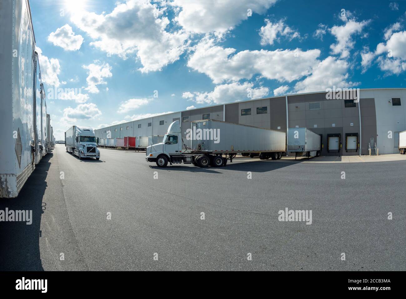 Warehouse with trucks Stock Photo - Alamy