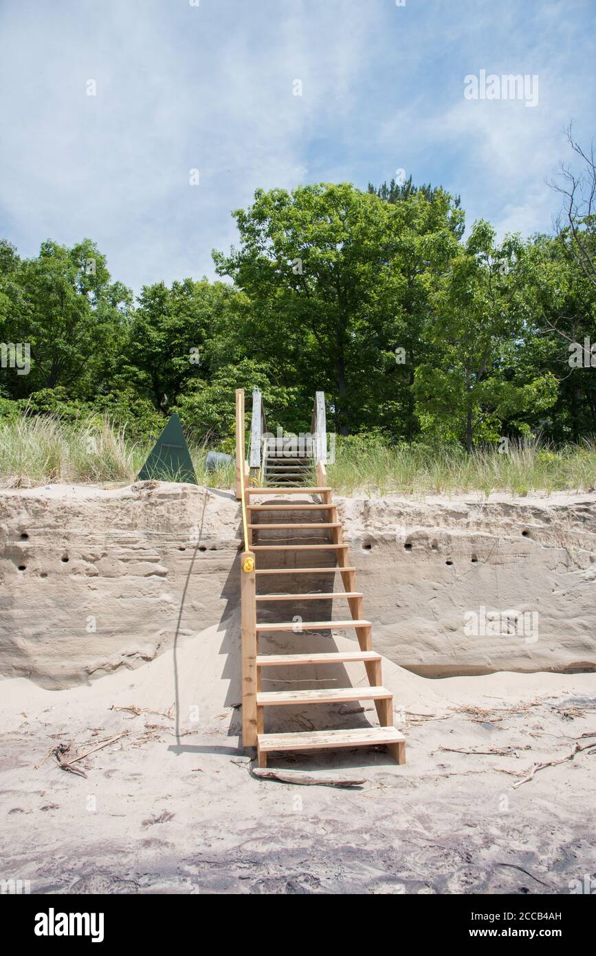 Manmade beach access steps in eroded dune after storm damage with ...