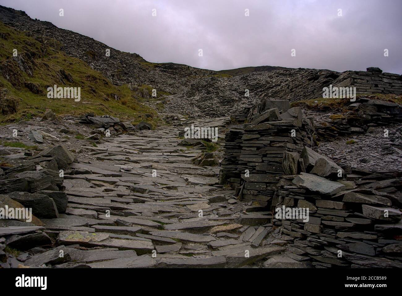 Ancient slate path running through stunning English rocky and grassy ...