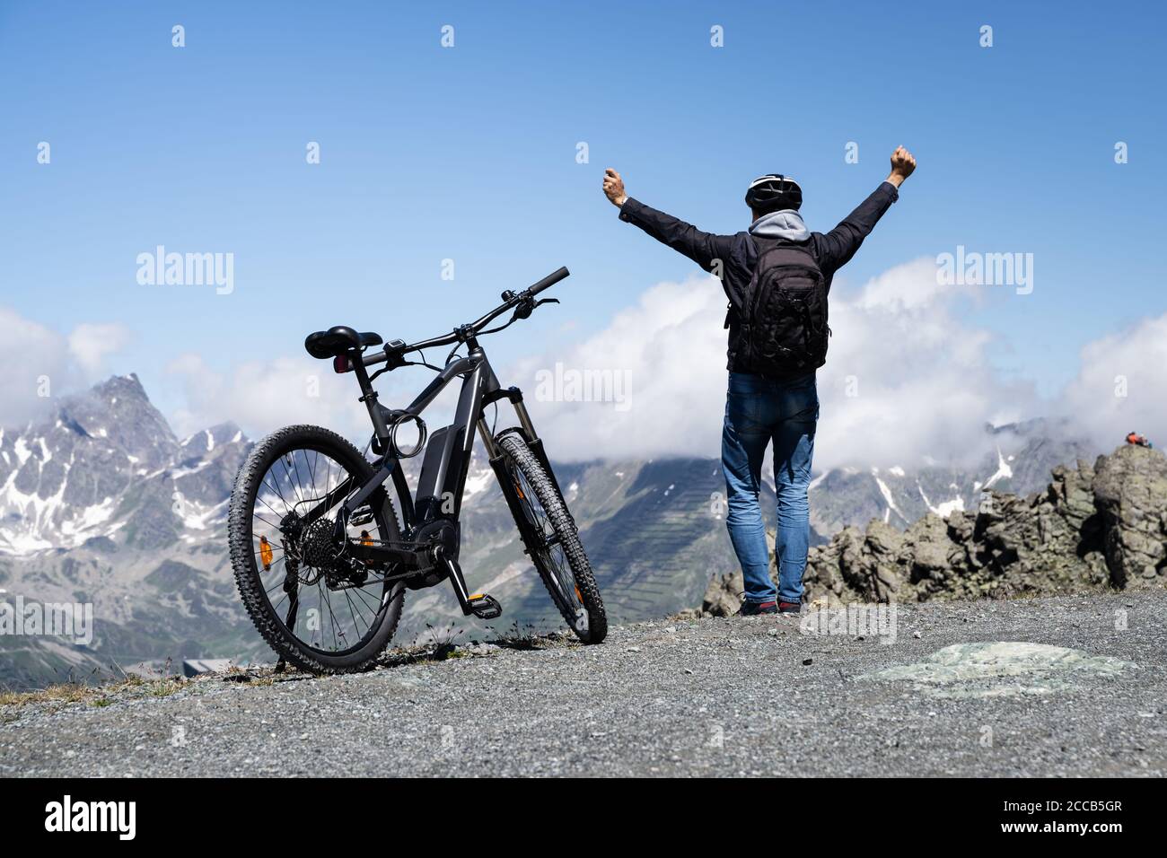 Young man cheering with bicycle hi-res stock photography and images - Alamy