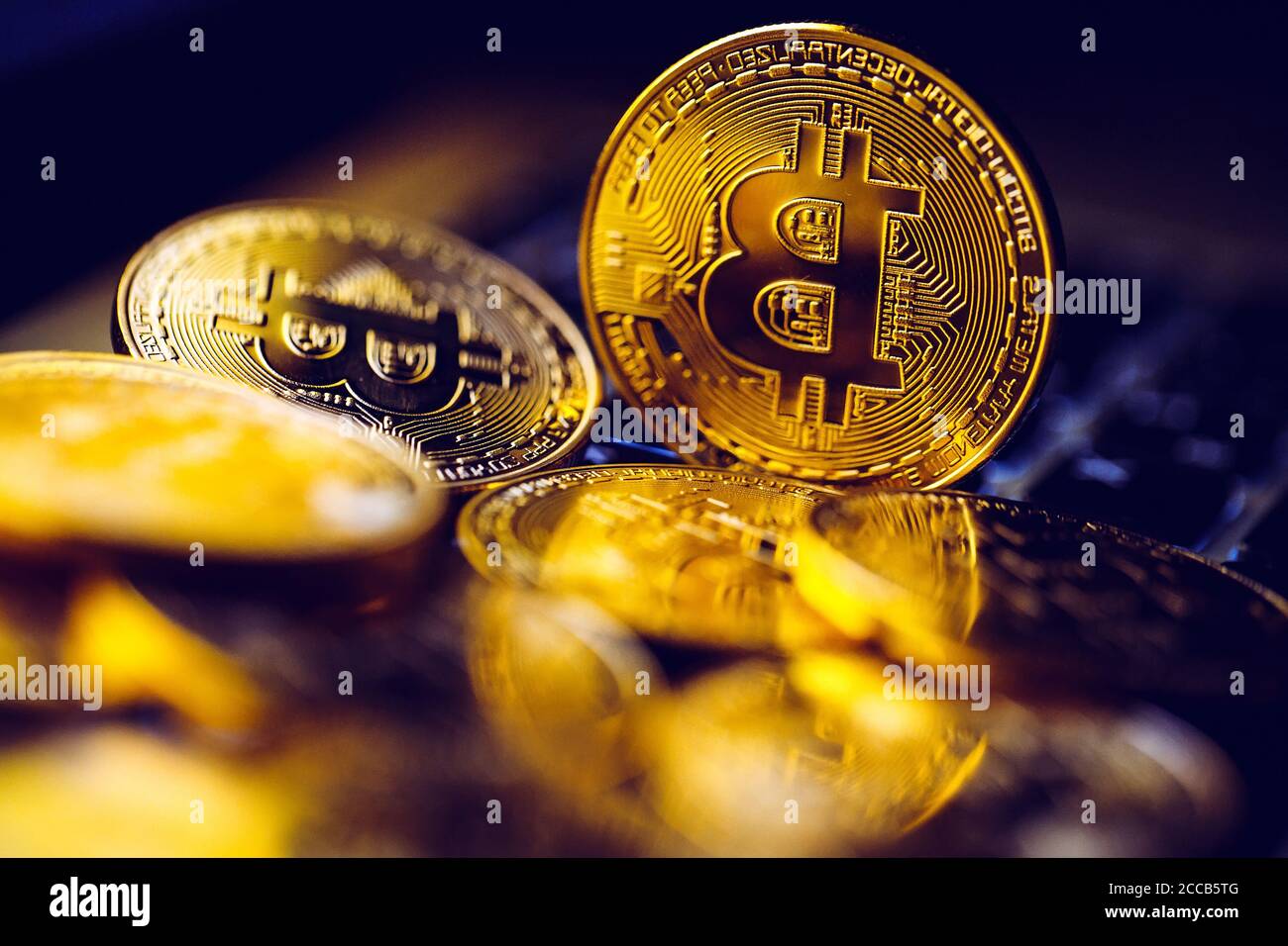 Bitcoin coins on laptop keyboard. Cryptocurrency background Stock Photo ...