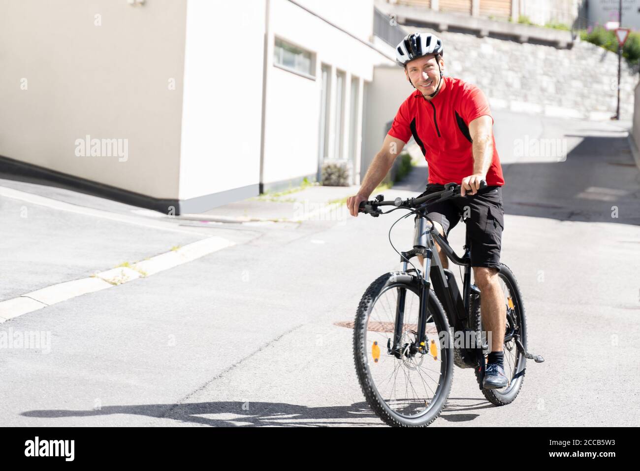 Man Riding E Bike Bicycle In City. Electric Bike In Summer Stock Photo ...