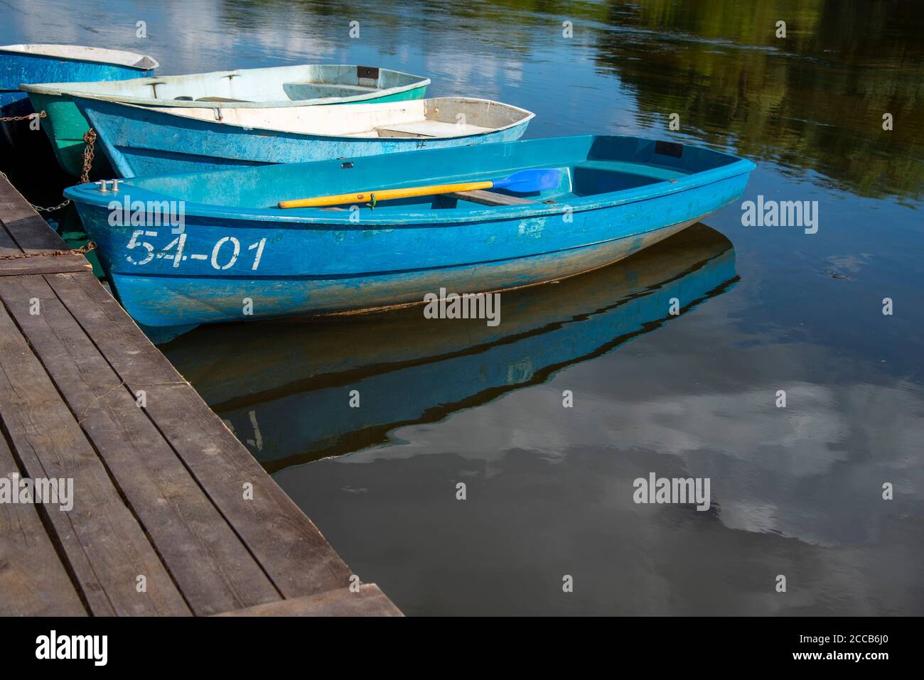 Wooden fishing rowing boats on the river Stock Photo - Alamy