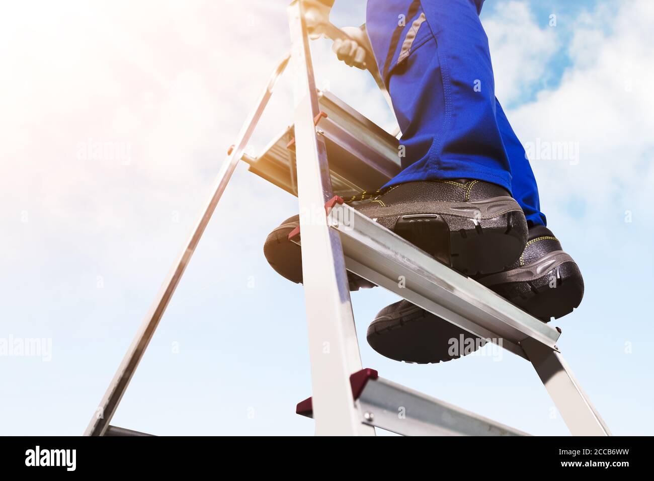 Work Man Working On Ladder Step. Safety And Danger Stock Photo - Alamy