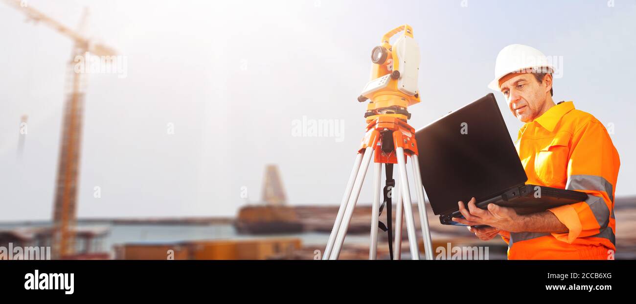 Land Surveyor Using Laptop Computer Software At Construction Site Stock ...