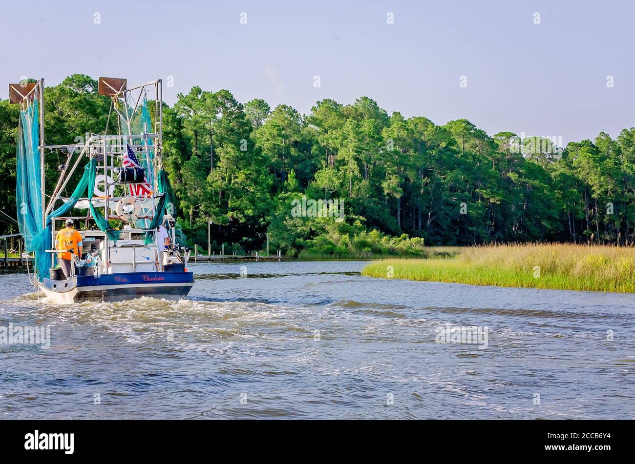 A shrimp boat travels down Fowl River, July 6, 2019, in Coden, Alabama ...