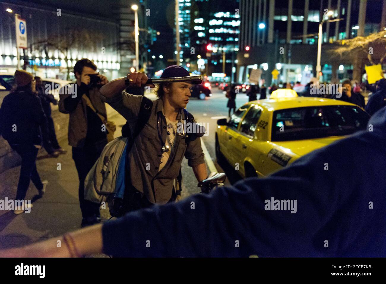 Seattle, USA – Jan 29, 2017: An angry man with a pipe confronting Anti ...