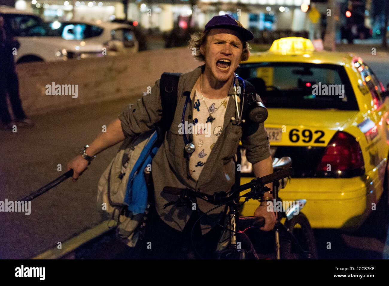 Seattle, USA – Jan 29, 2017: An angry man with a pipe confronting Anti ...